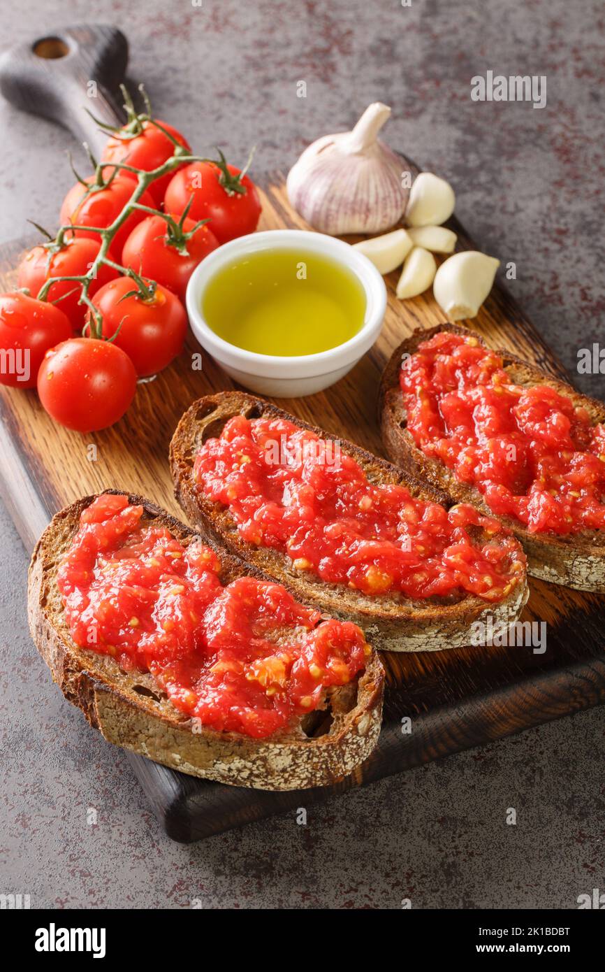 Spanish style toast with tomato Pan con tomate closeup on the wooden ...
