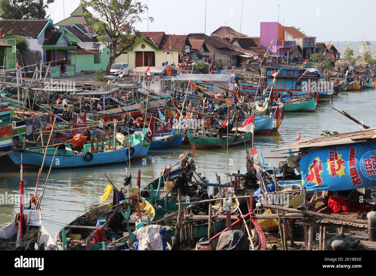 A harbor with colorful fishing ships and small passenger boats Stock ...