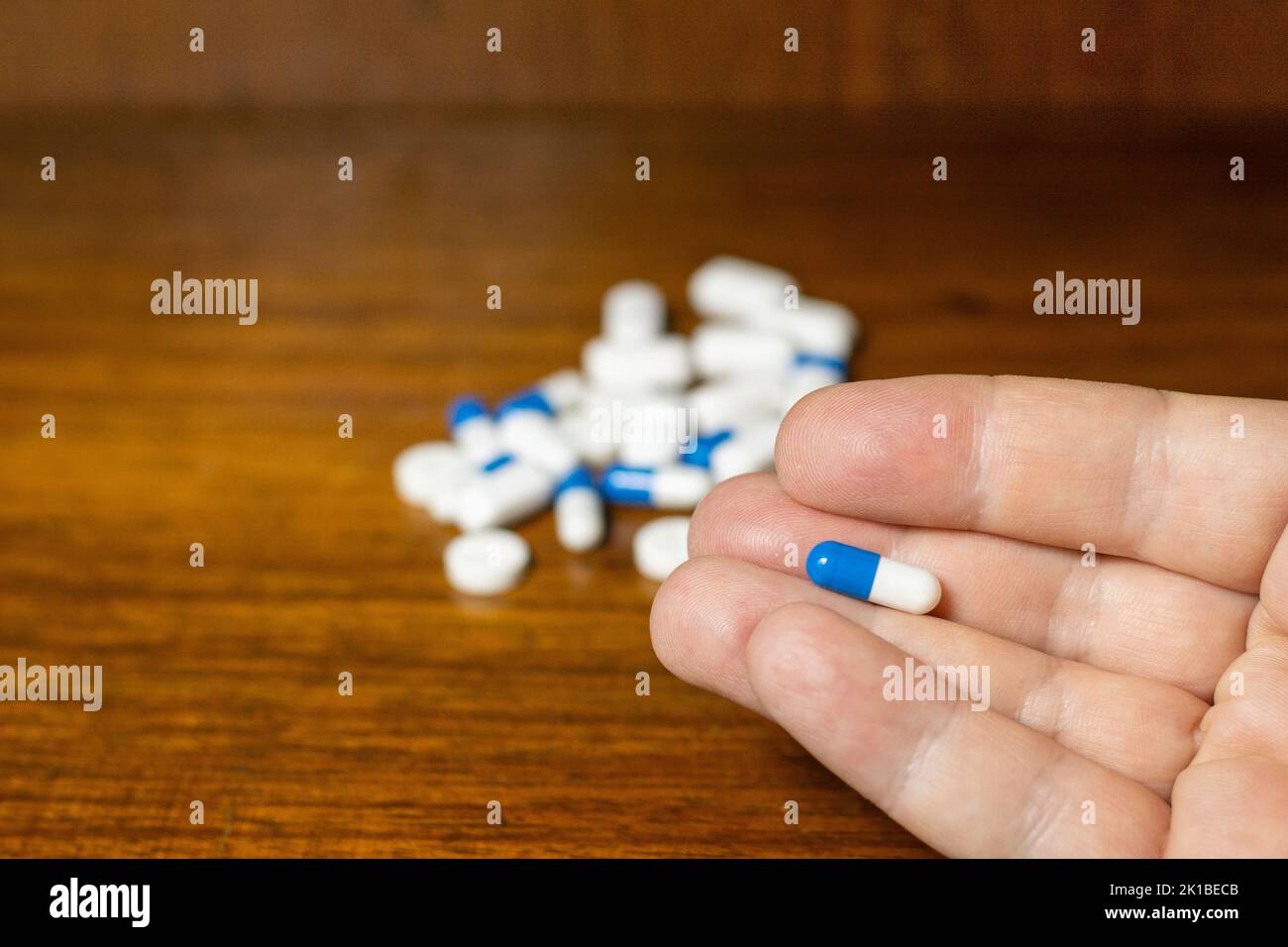 Simple pile of white, blue and yellow pills, medicines, pills stacked ...