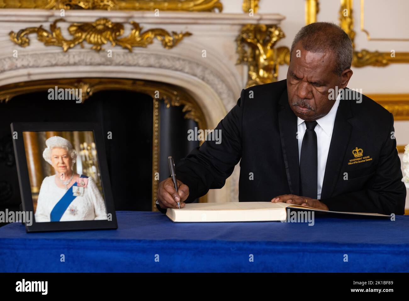 Sir Bob Dadae, Governor-General of Papua New Guinea, signs a book of ...