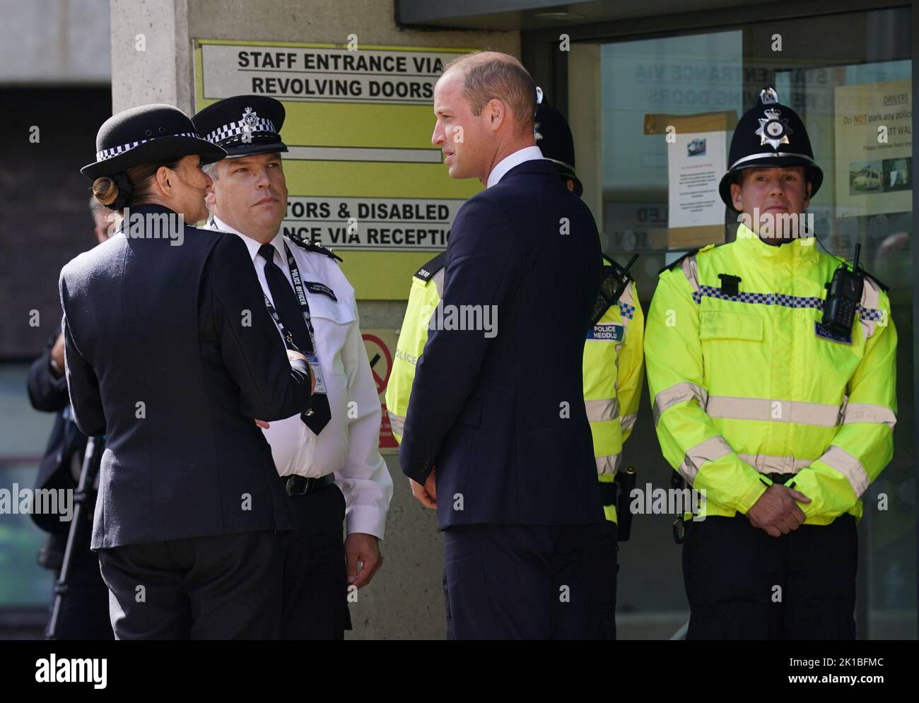 The Prince of Wales speaks to members of staff as he and King Charles ...