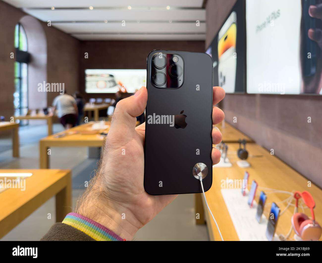 Paris, France - Sep 16, 2022: POV male hand holding rear triple camera of Apple Computers iPhone ...