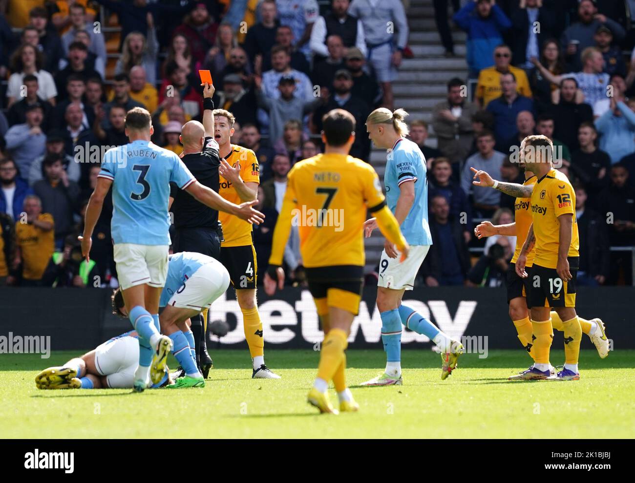 Referee Anthony Taylor shows a red card to Wolverhampton Wanderers ...