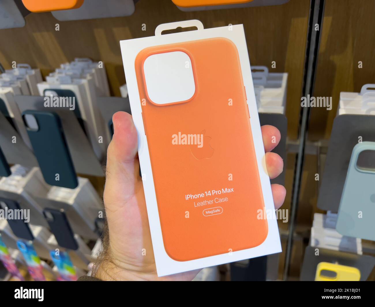 Paris, France - Sep 16, 2022: POV male hand holding package in Apple Store shopping with new ...