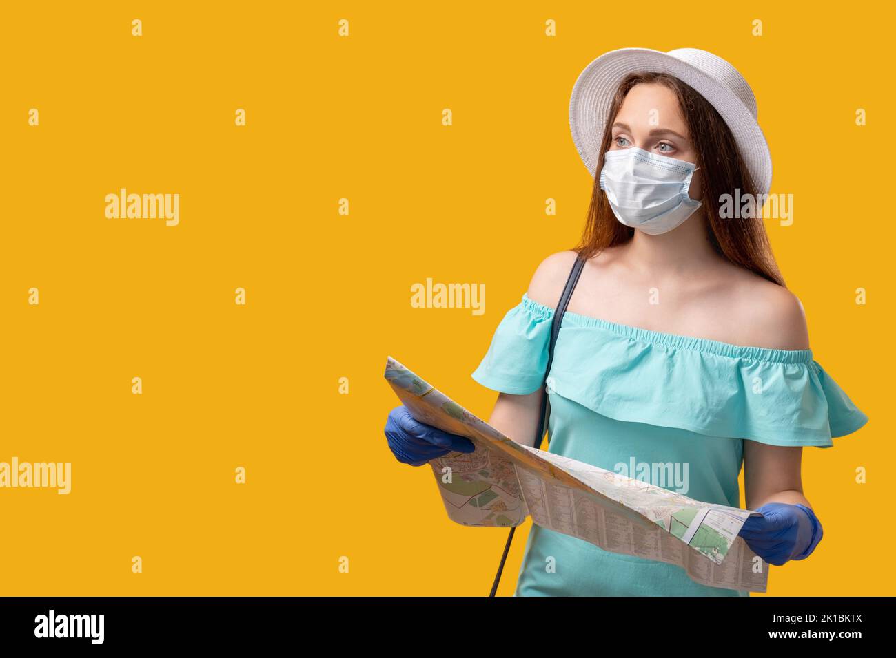 Pandemic tourism. Travel agency. Curious woman in protective face mask ...