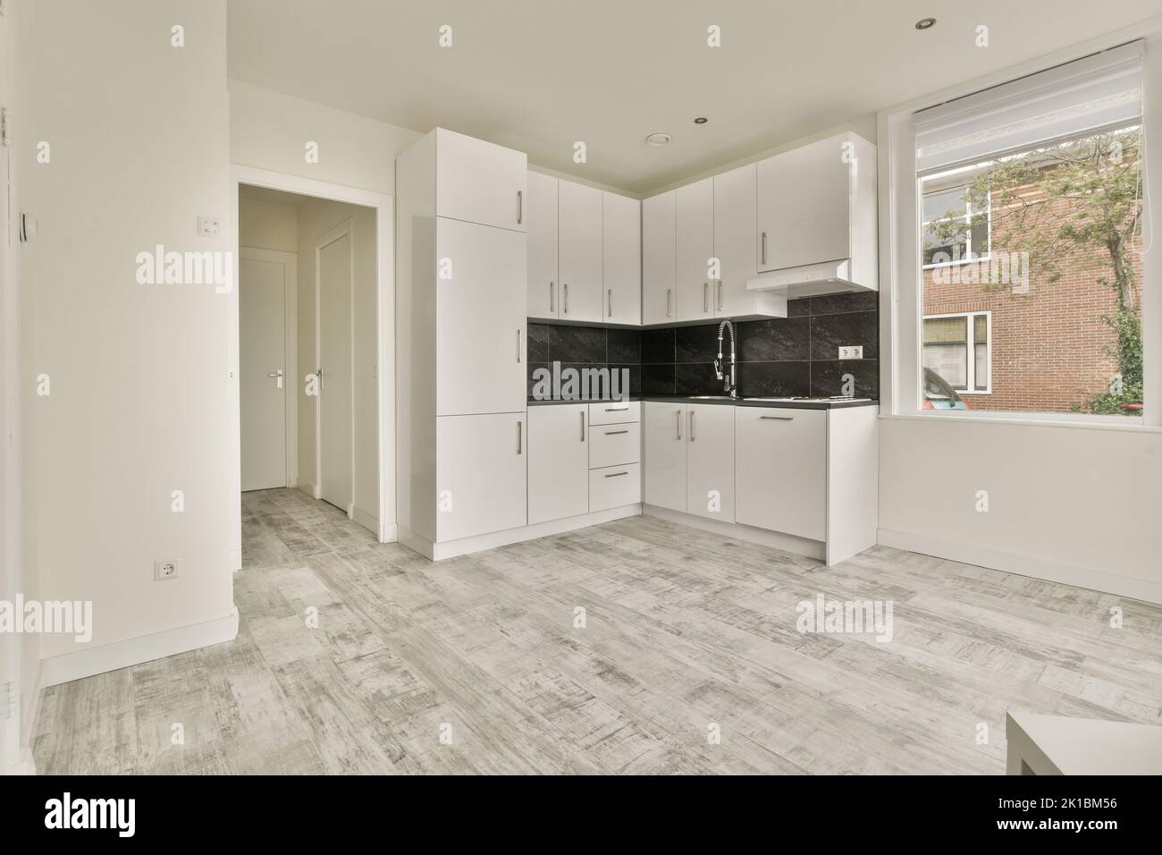 Spacious living room with open kitchen Stock Photo - Alamy