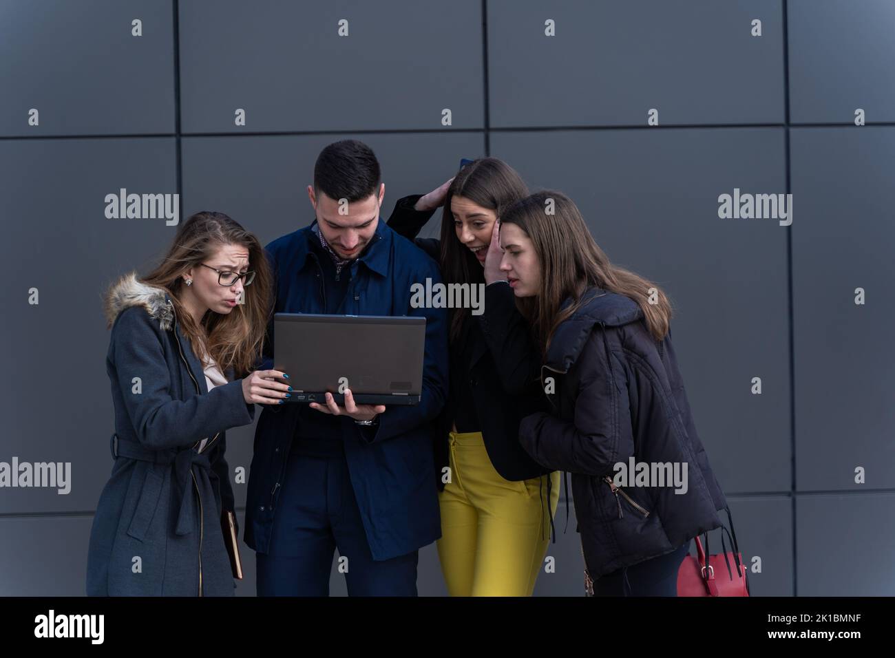 Group of young business people are looking at the lap top and being ...