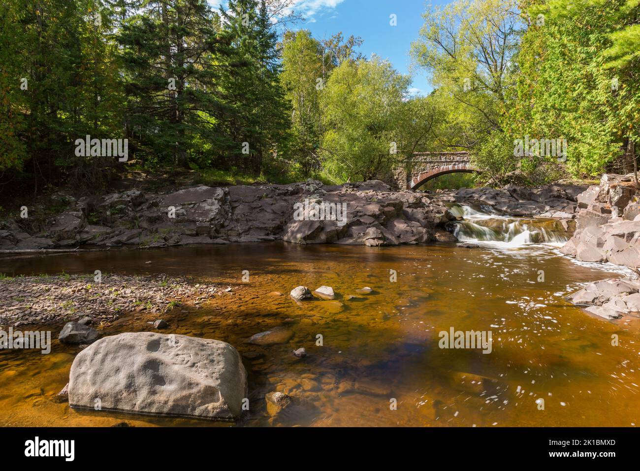 Amity Creek with Stone Arch Bridge In Autumn Stock Photo - Alamy