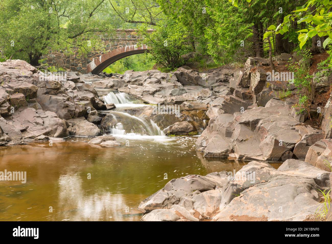 Amity Creek and Stone Arch Bridge In Summer Stock Photo - Alamy
