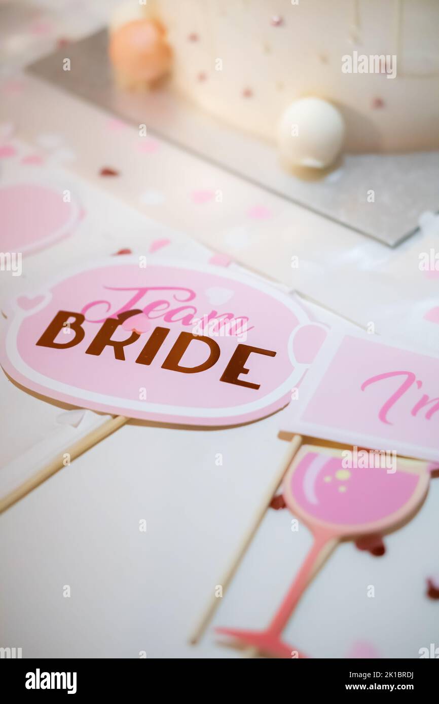 A vertical shot of team bride signs in pink color Stock Photo - Alamy