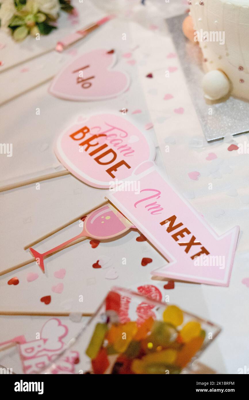 A vertical shot of team bride signs in pink color Stock Photo - Alamy