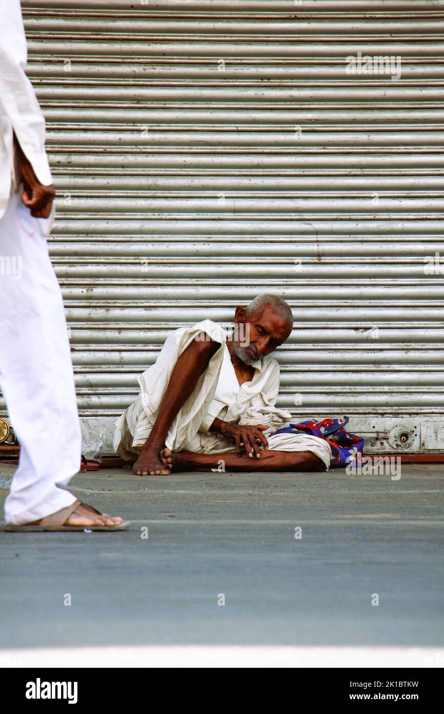 A vertical shot of an old male beggar on there streets of India Stock ...