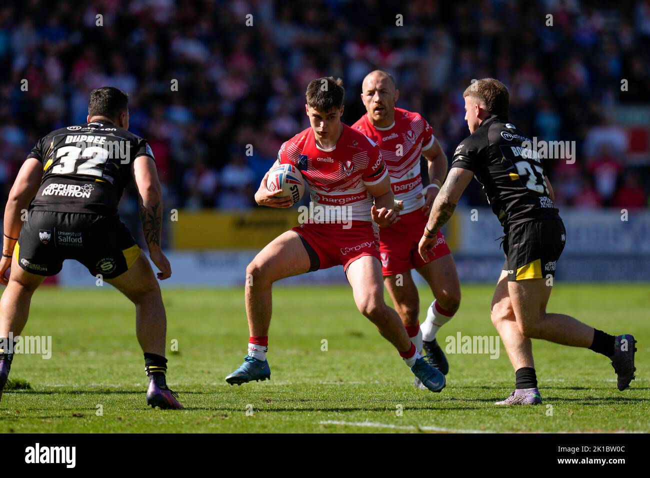 Joe Bennison #27 of St Helens runs at the Salford Red Devils defence ...