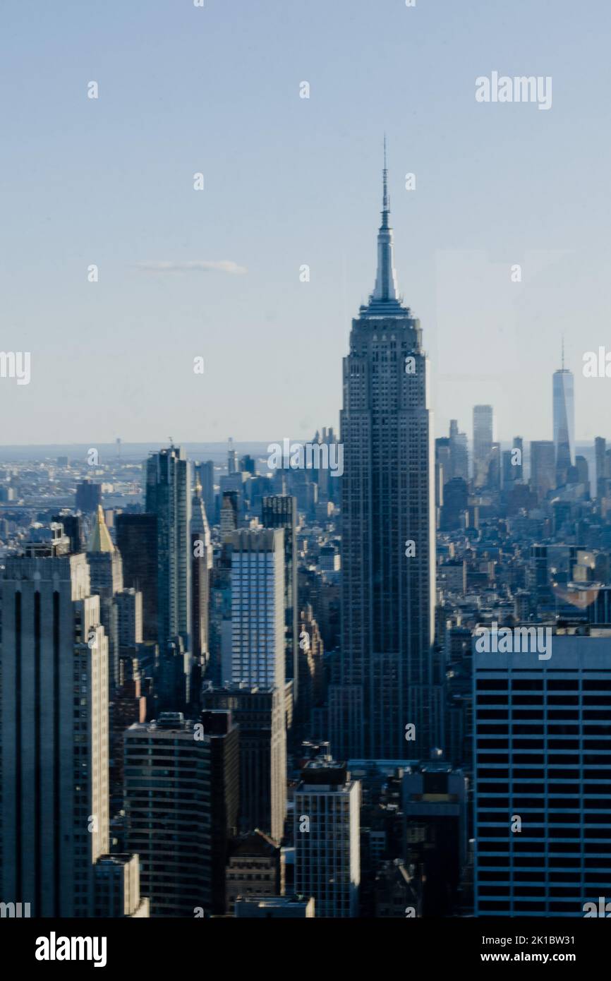 A vertical shot of the NYC cityscape with the Empire state building in ...