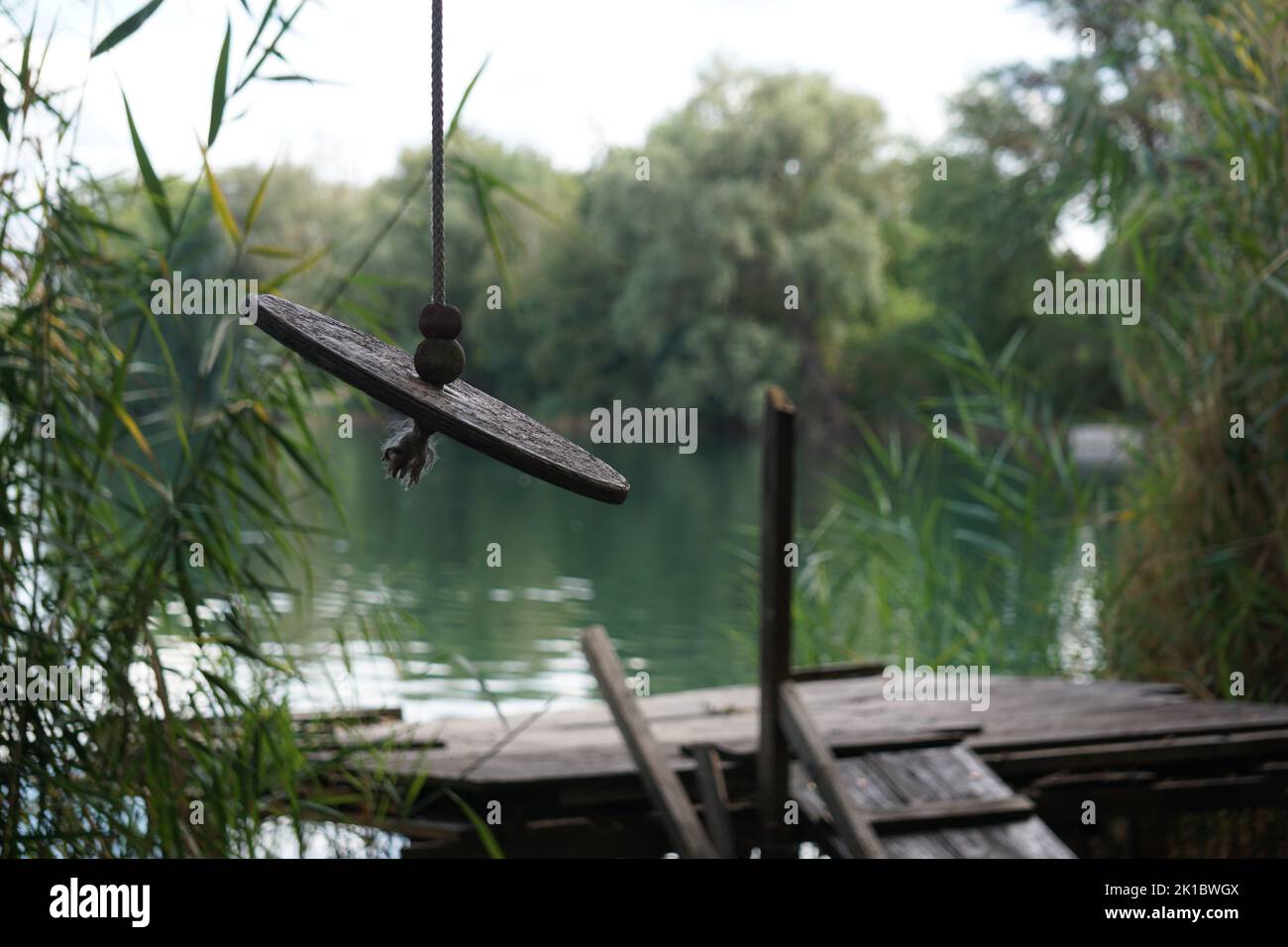 The wooden structure before the lake is surrounded by greenery Stock ...