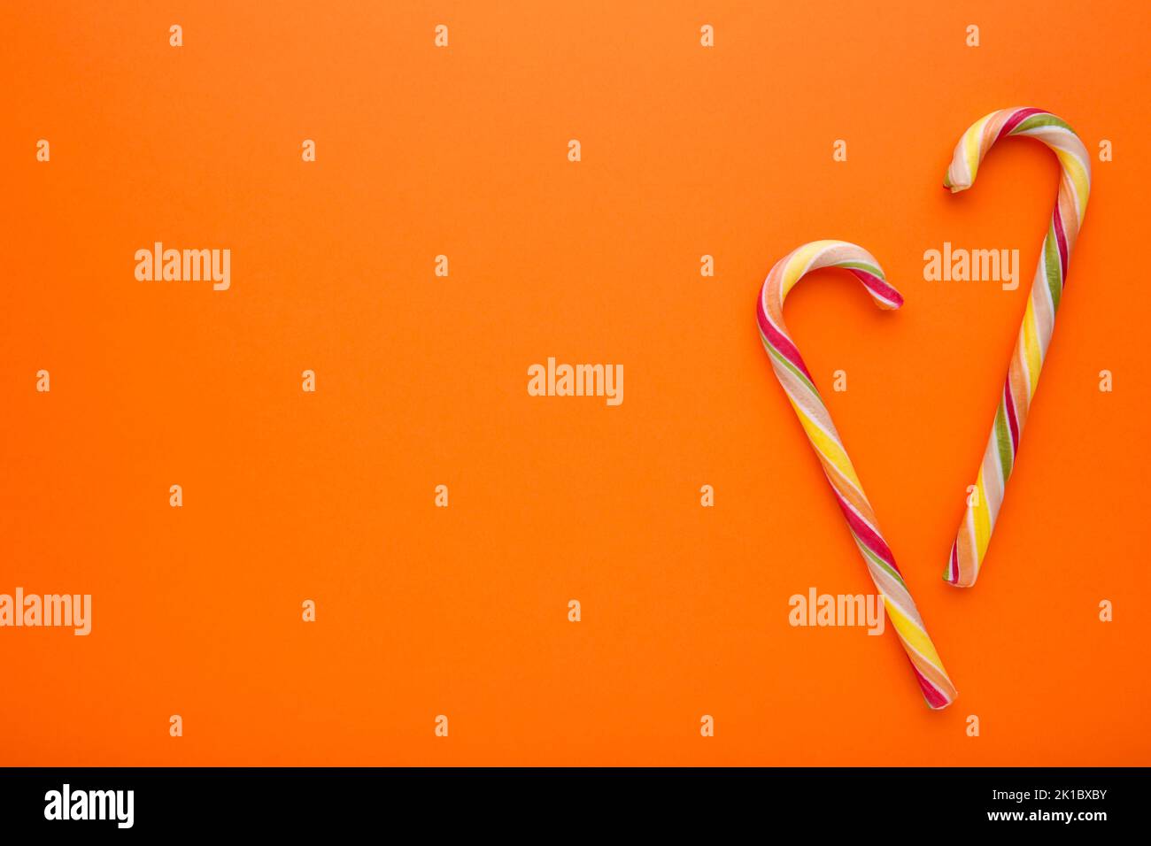 Lollipops on orange background. Studio shot Stock Photo - Alamy