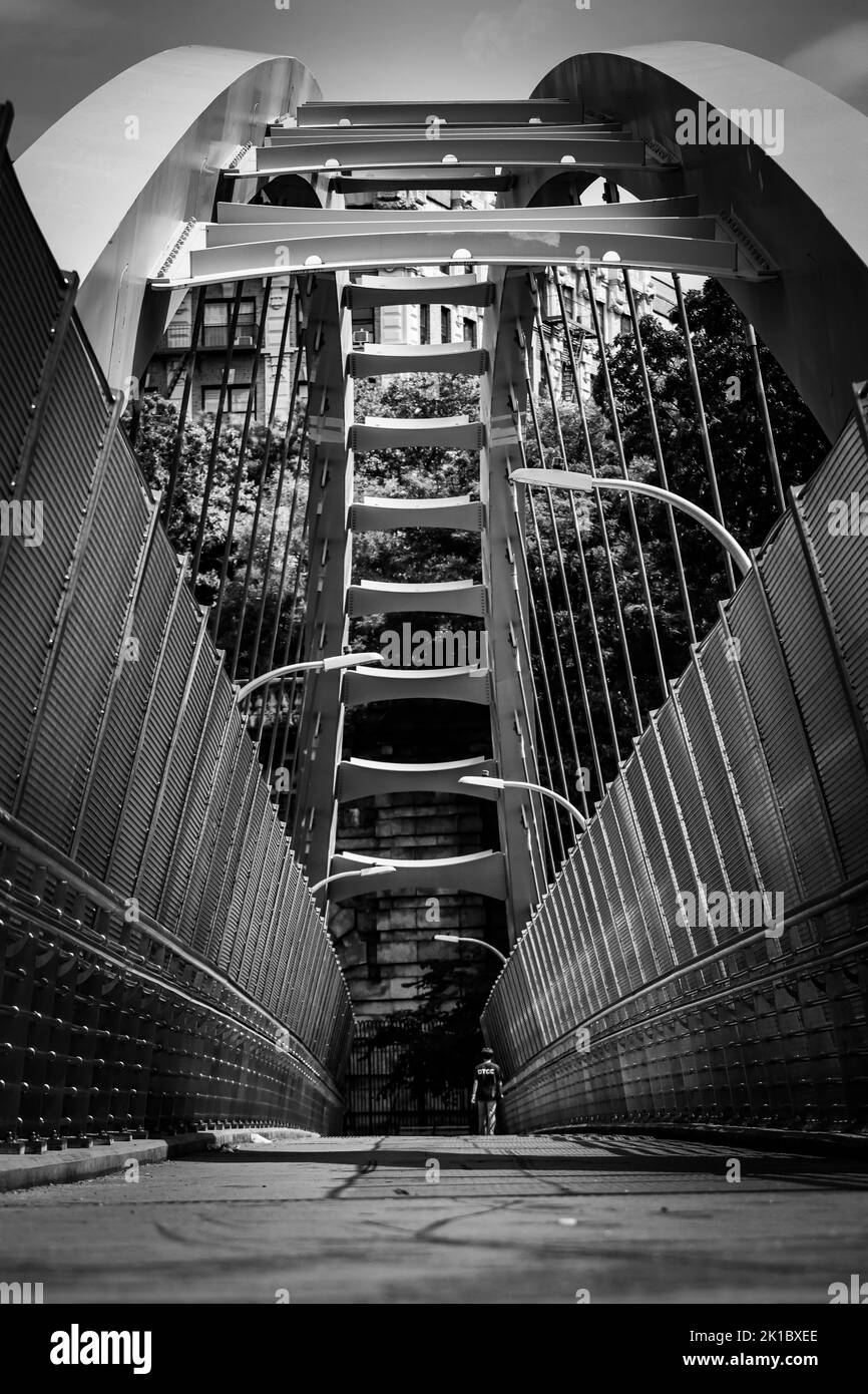 A vertical grayscale shot of a modern pedestrian bridge Stock Photo - Alamy