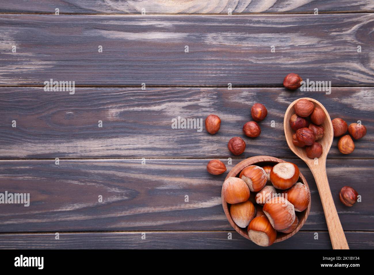 Delicious hazelnut in the wooden bowl on brown background Stock Photo ...