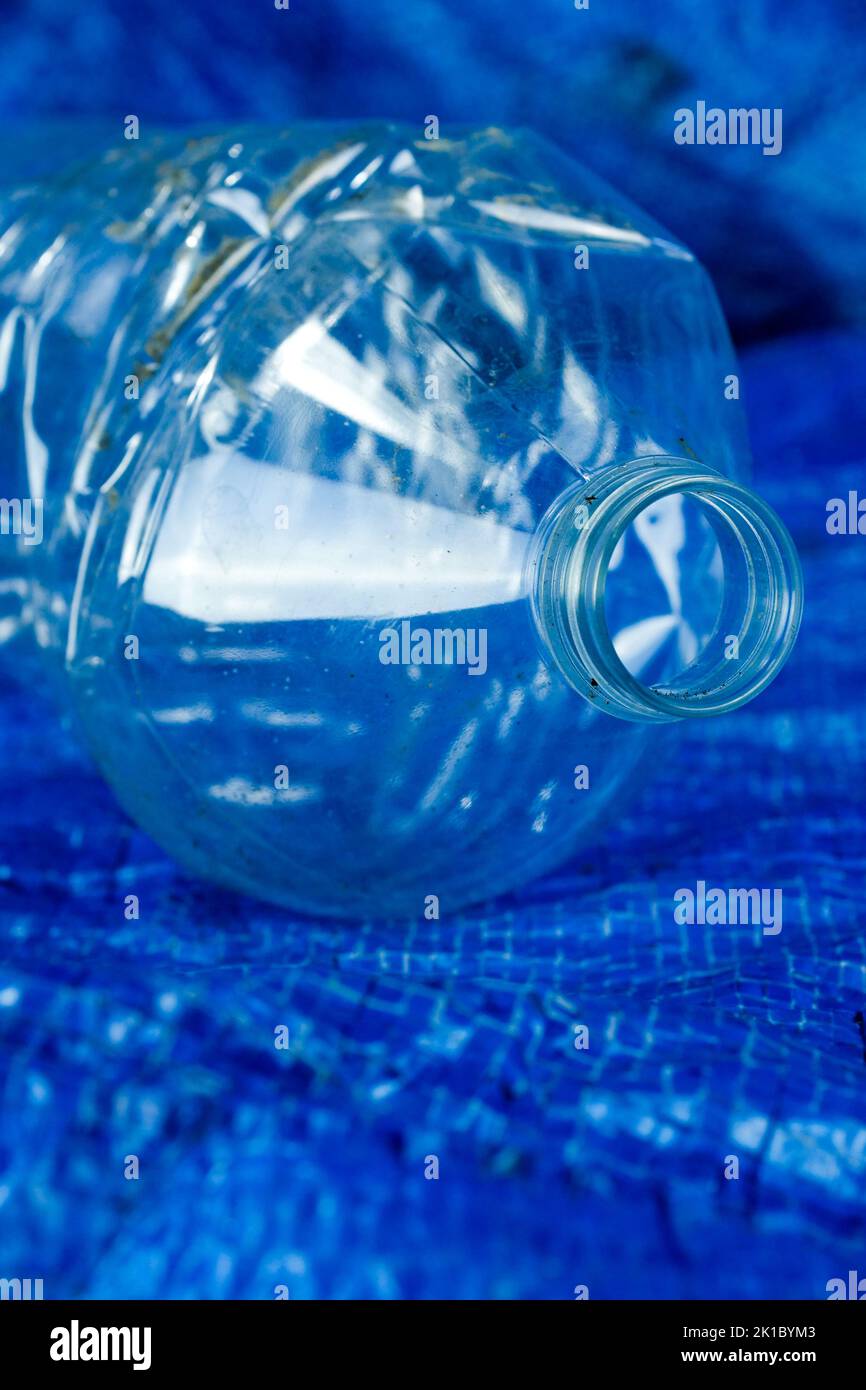 Translucent plastic bottle displayed on a blue tarpaulin, Studio ...