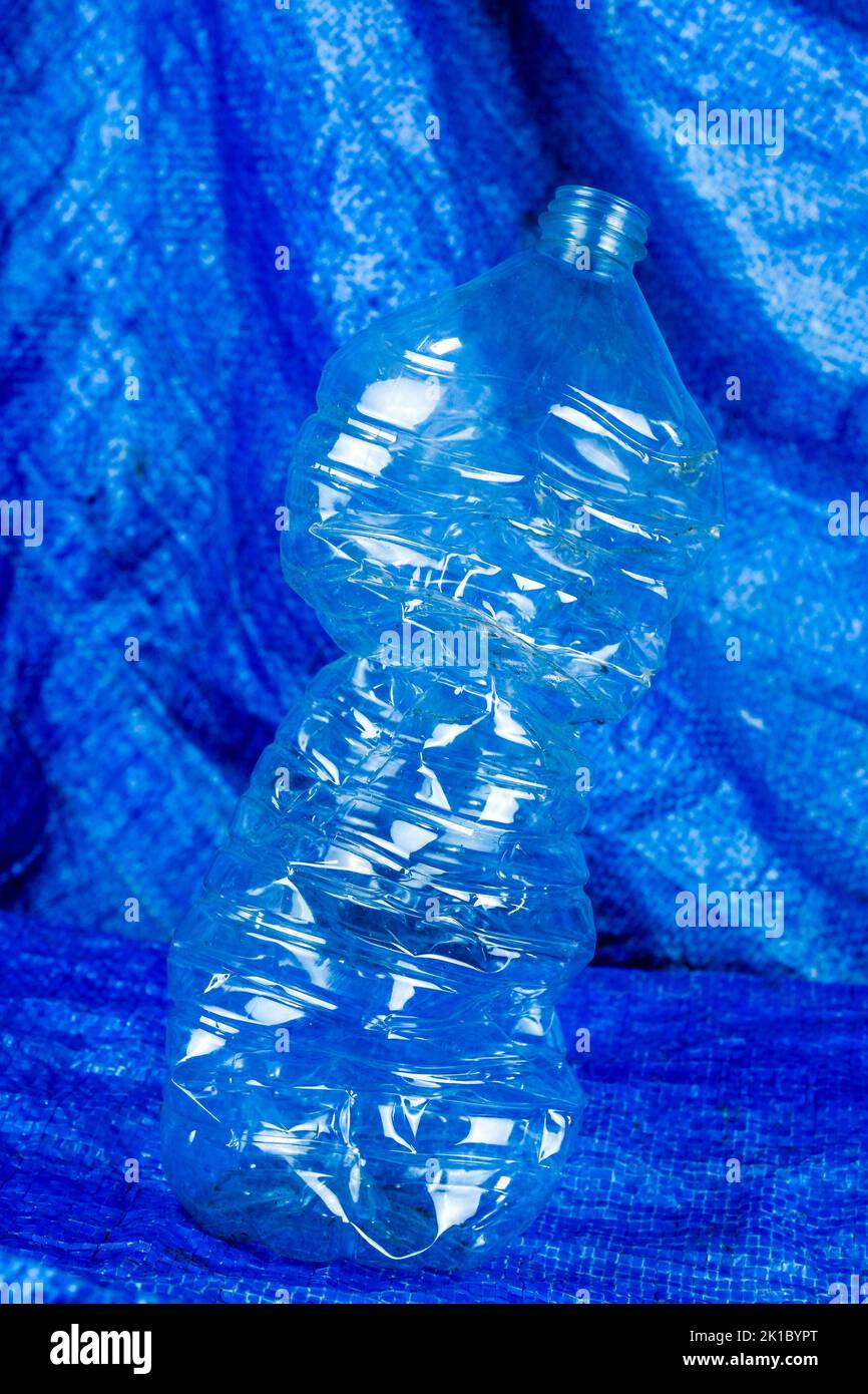 Translucent plastic bottle displayed on a blue tarpaulin, Studio ...