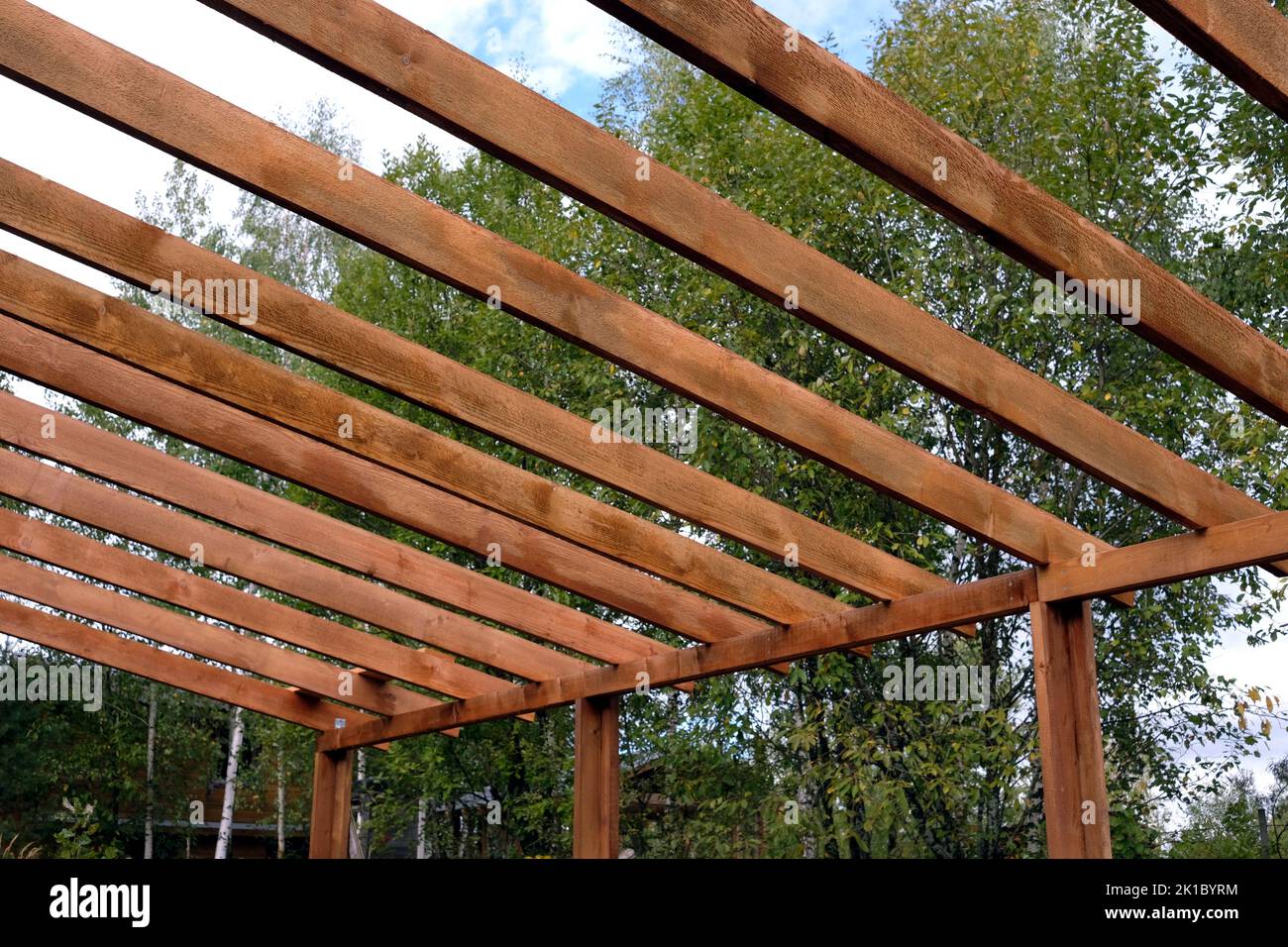 The process of building a wooden canopy from brown boards in the ...