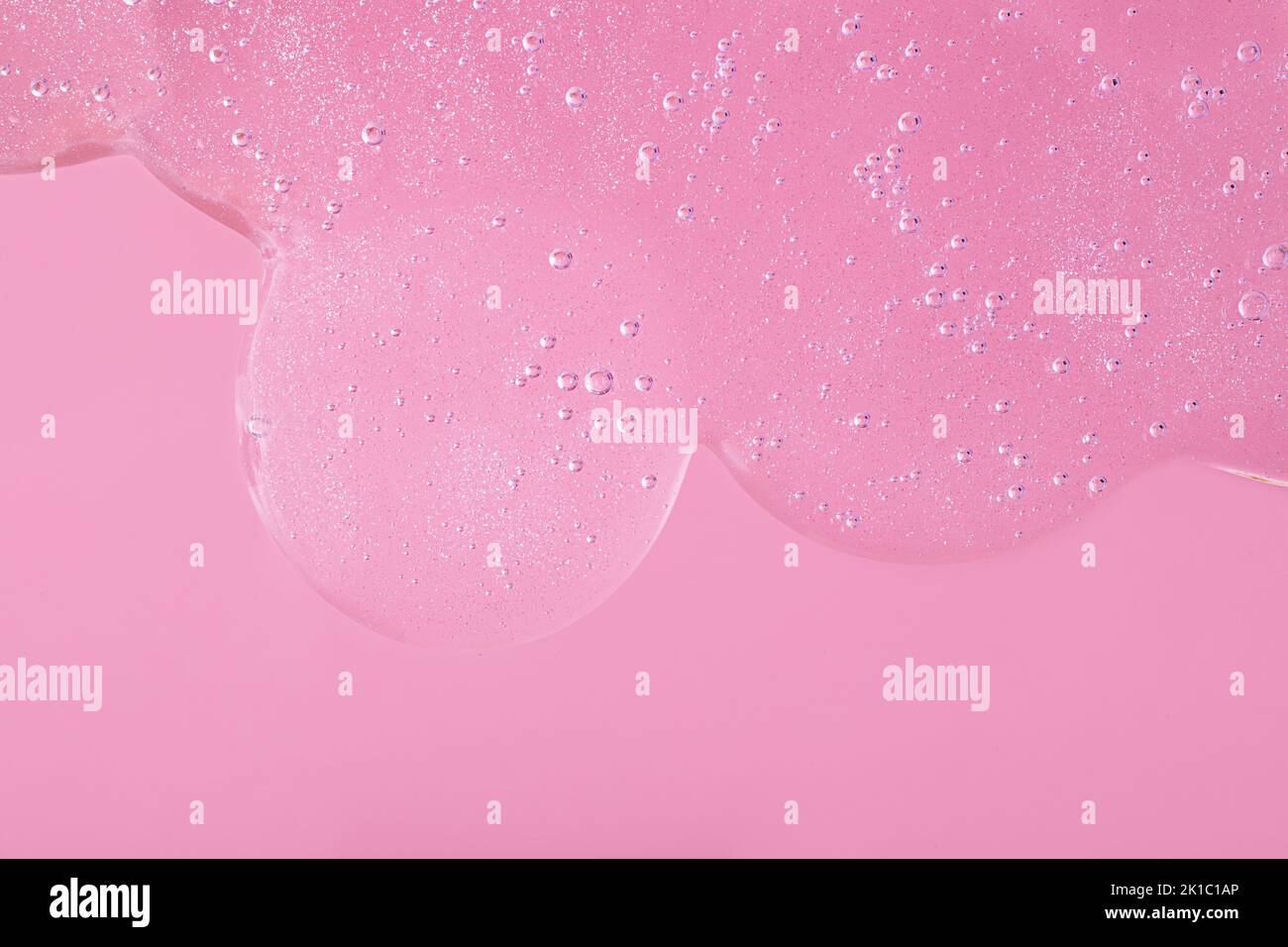 Macro photography of bubbly smear on raspberry pink background with ...