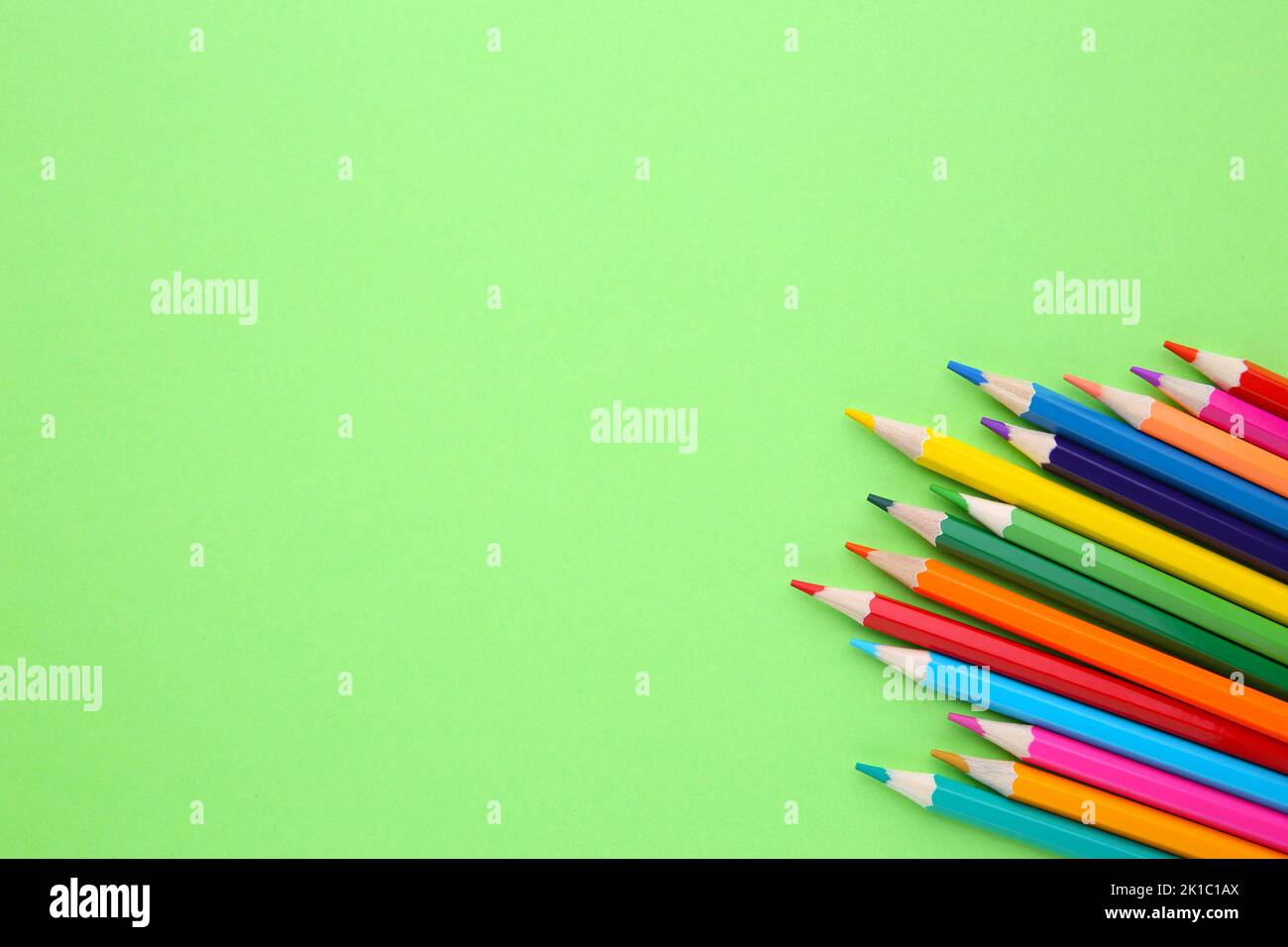 Many different colored pencils on lime background Stock Photo - Alamy