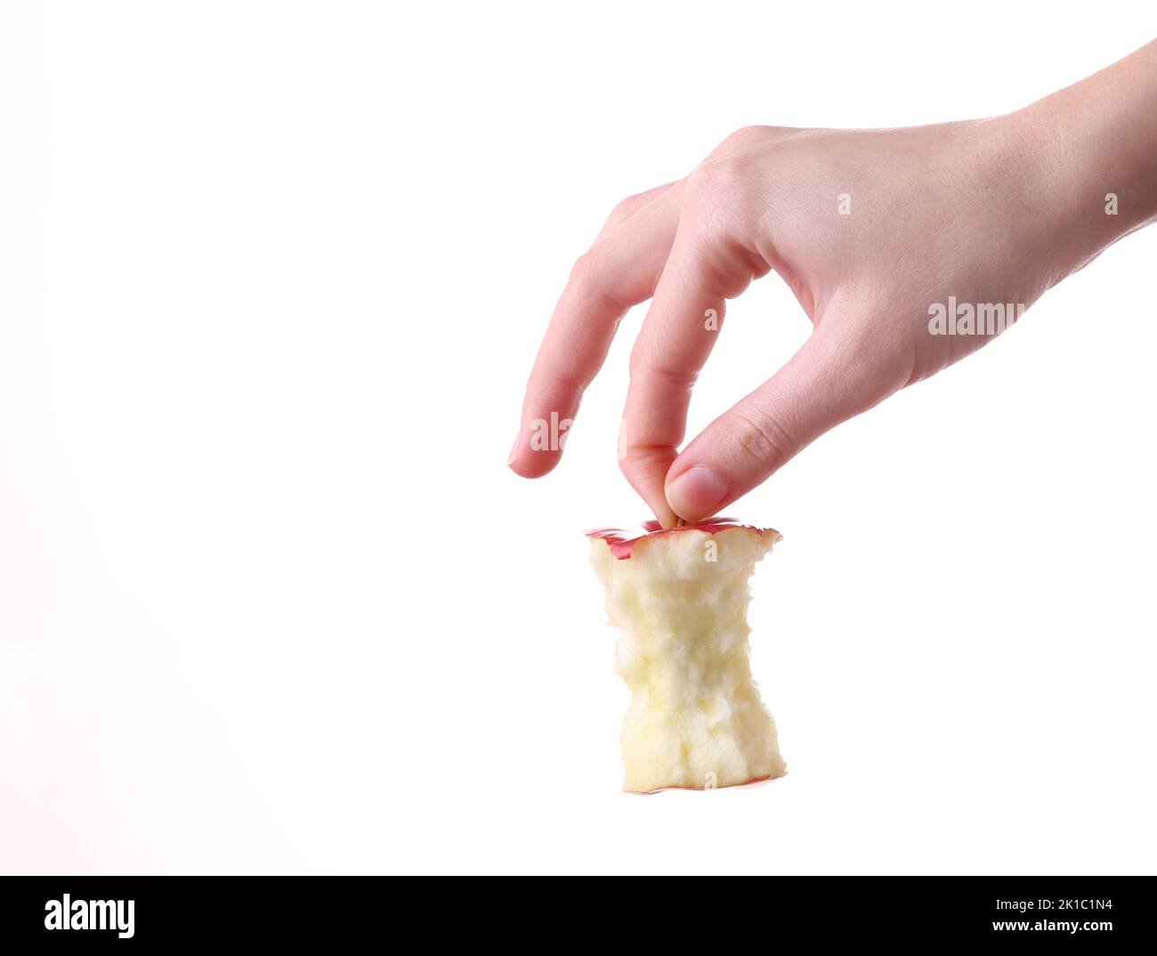 Hand holding apple stub isolated on a white background Stock Photo - Alamy