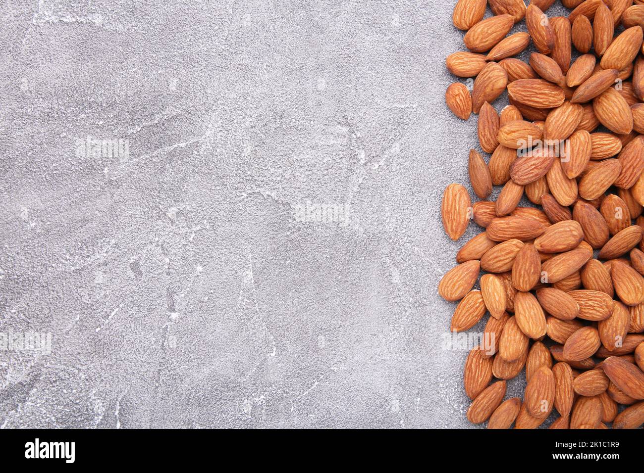 Group of almonds on grey concrete background, frame Stock Photo - Alamy