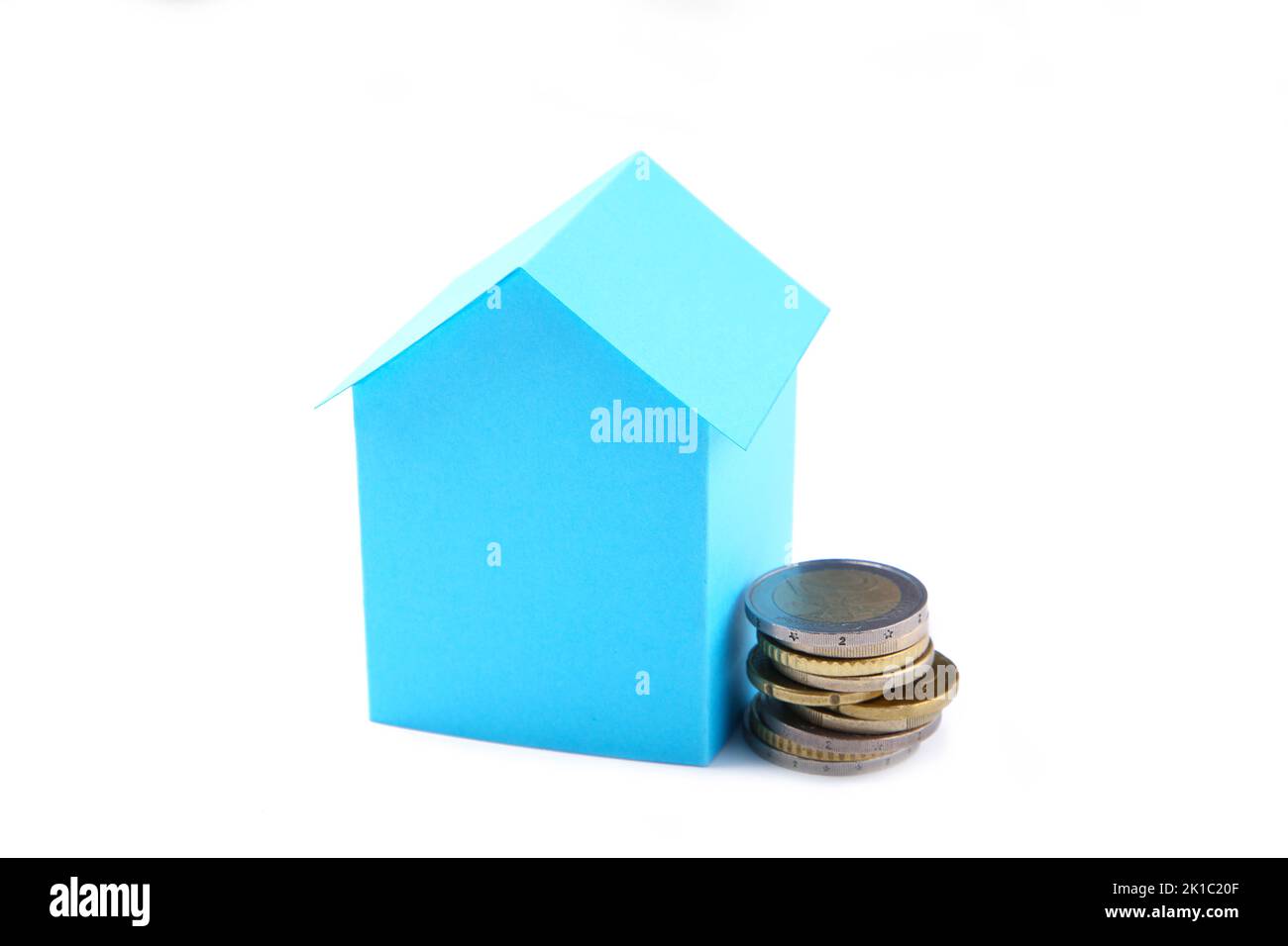 Blue paper house with coins on a white background Stock Photo - Alamy