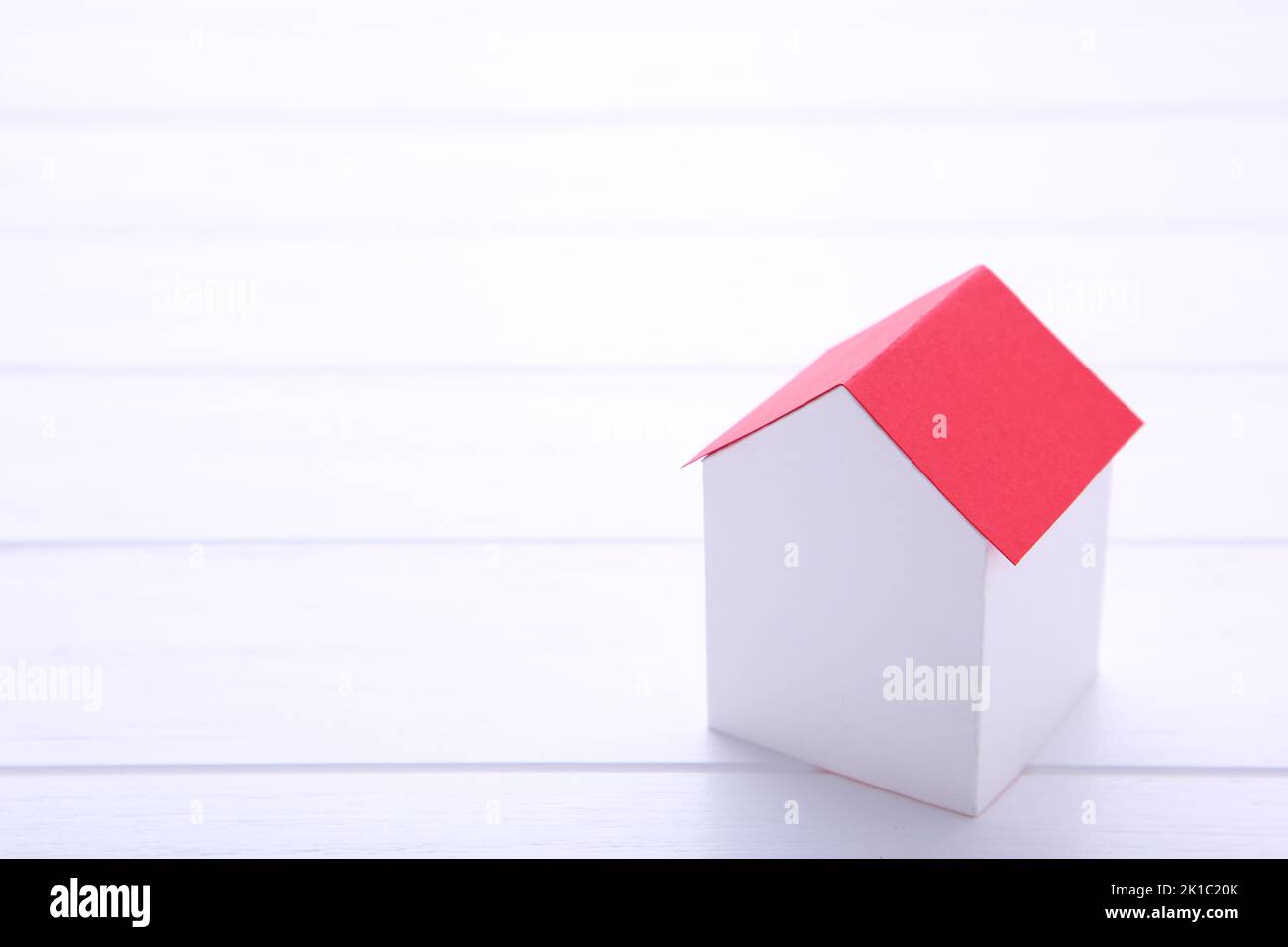 White paper house with red roof on a white background Stock Photo - Alamy