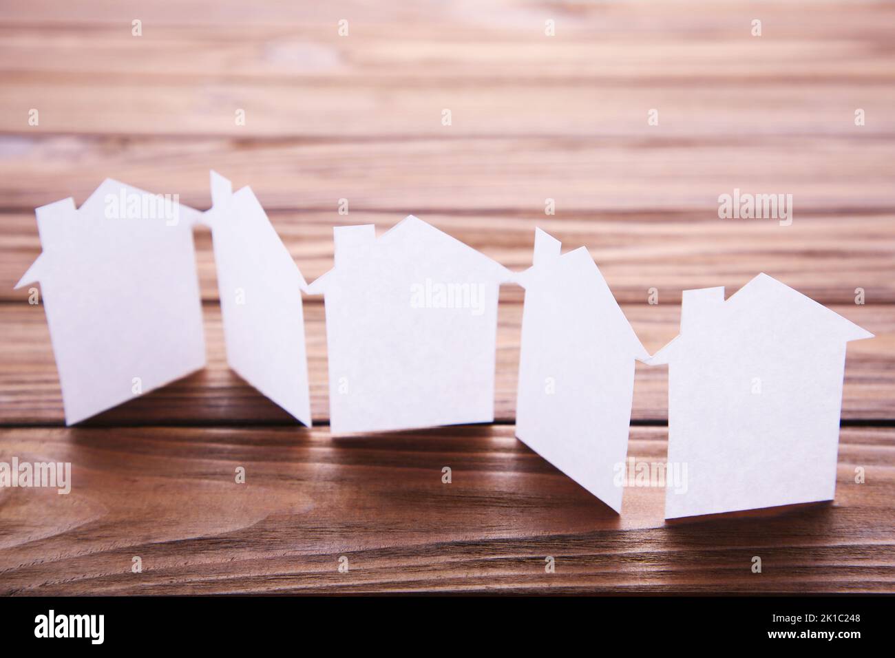 Paper town. Papercraft house and papercraft building on brown ...