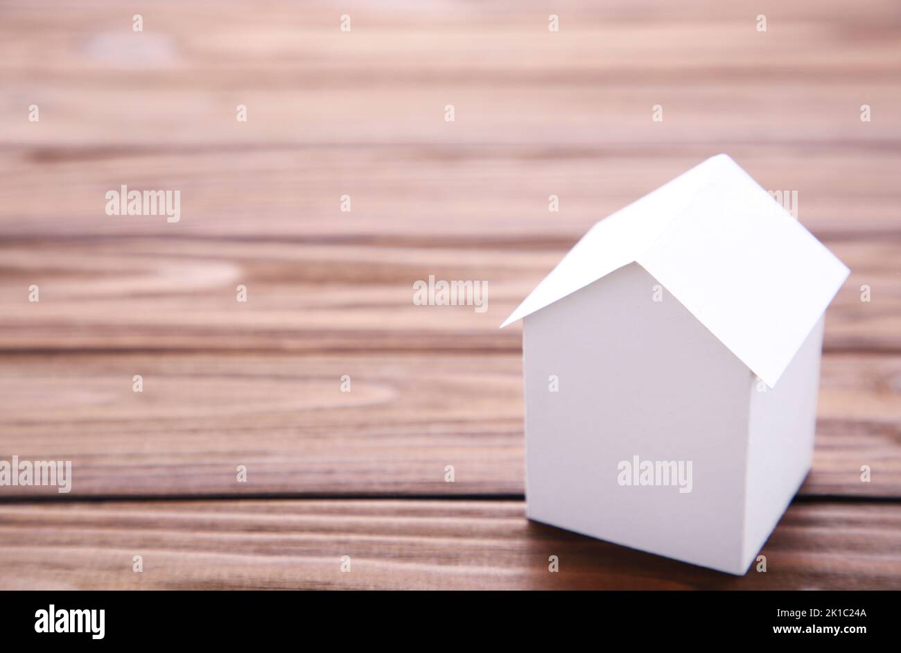 Concept of house in paper on wood. Horizontal composition. Top view ...