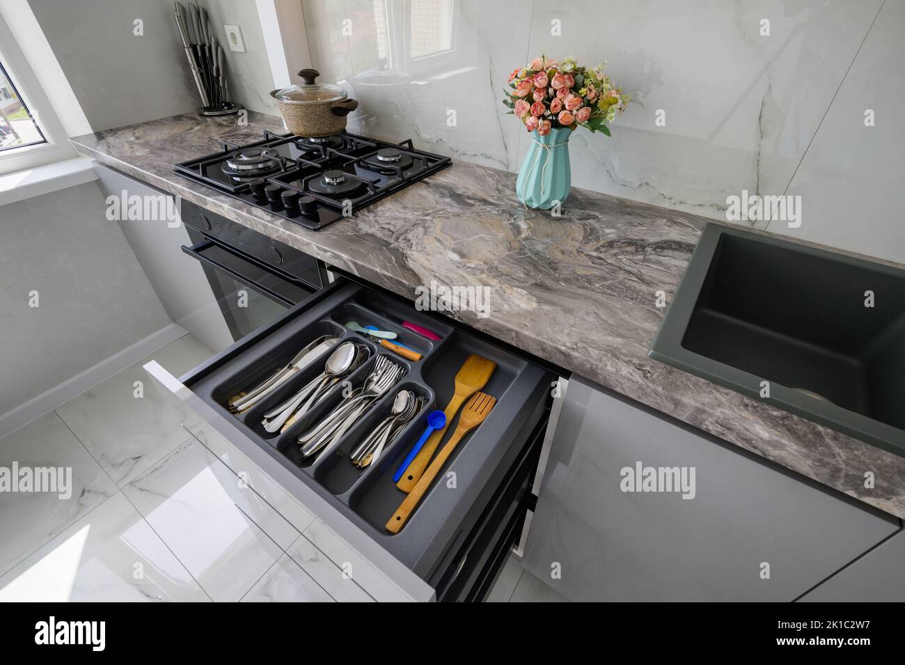 High angle closeup view to open drawer of grey and white modern ...