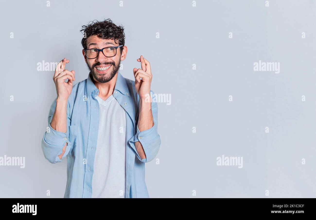 Concept of positive person making a wish and crossing his fingers on ...