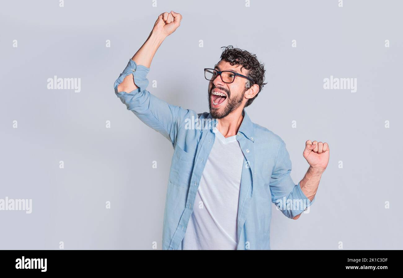 Handsome man raising his hand in victory isolated, Person celebrating ...