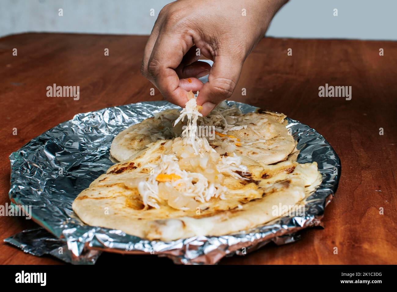 Nicaraguan pupusas with salad on aluminum foil, View of delicious ...