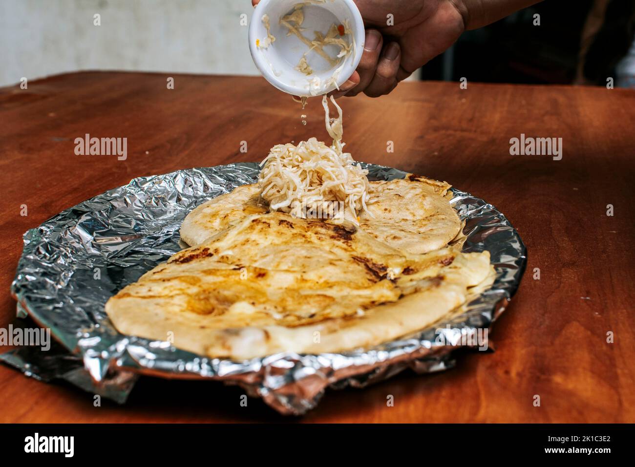 Traditional pupusas served with salad on the table. Nicaraguan pupusas ...