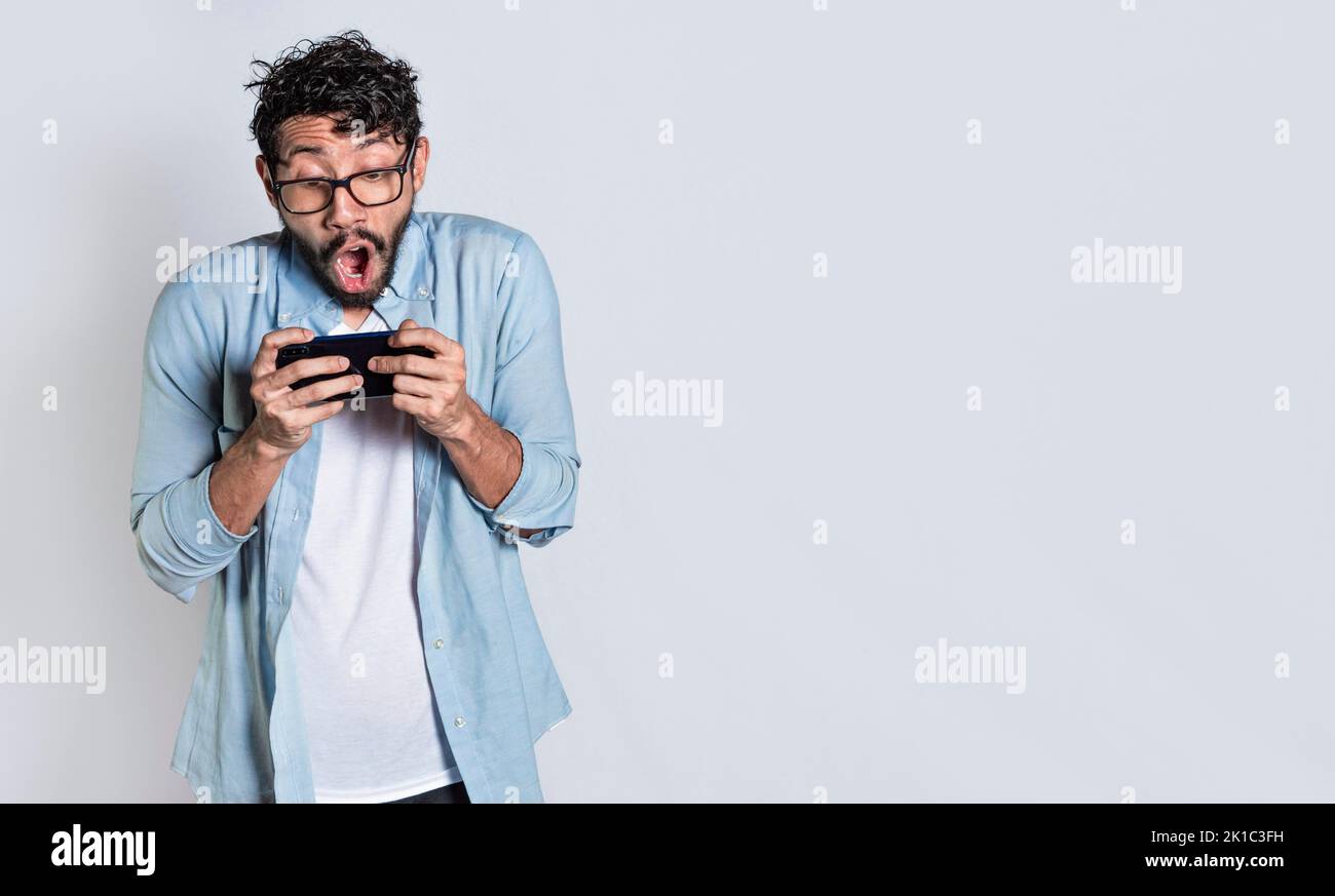 Surprised people watching an advertisement on their cell phone. Amazed ...