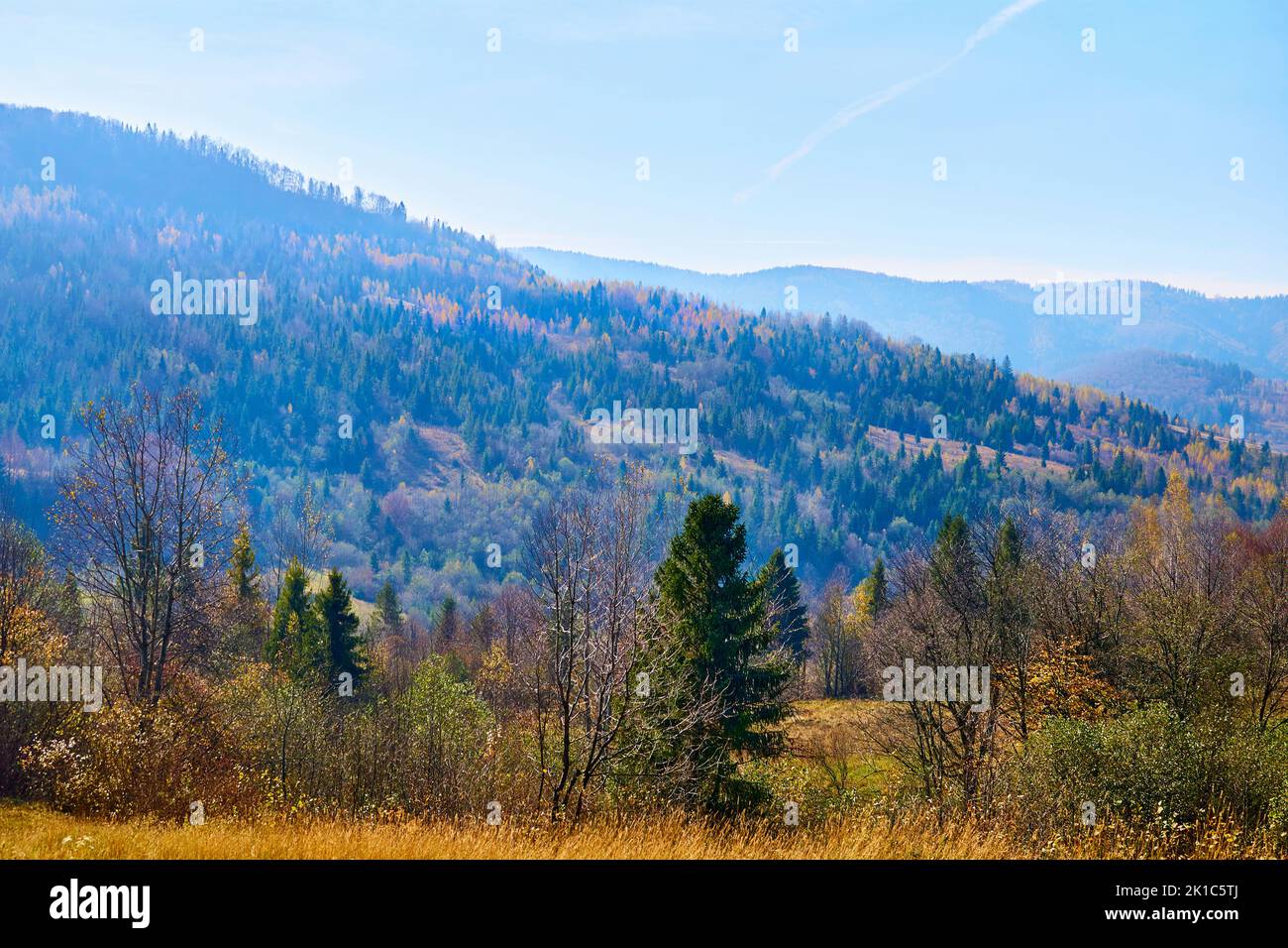 Aerial view of an autumn small village in a valley and mountains in a ...