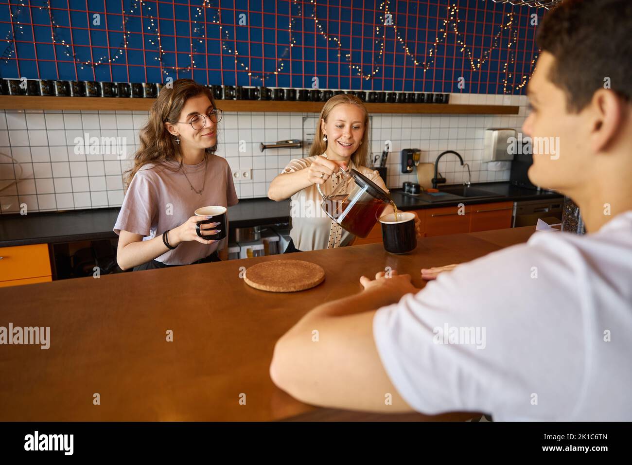 Three colleagues have an informal conversation during a break Stock ...