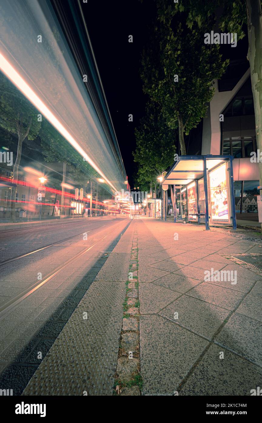 Long exposure of a passing tram at night in the city centre of Jena ...