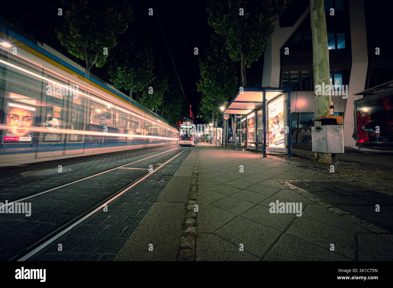 Long exposure of a passing tram at night in the city centre of Jena ...