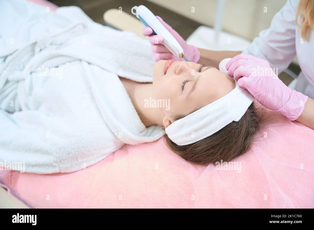 Girl lies during ultrasound of skin with scrubber in salon Stock Photo ...