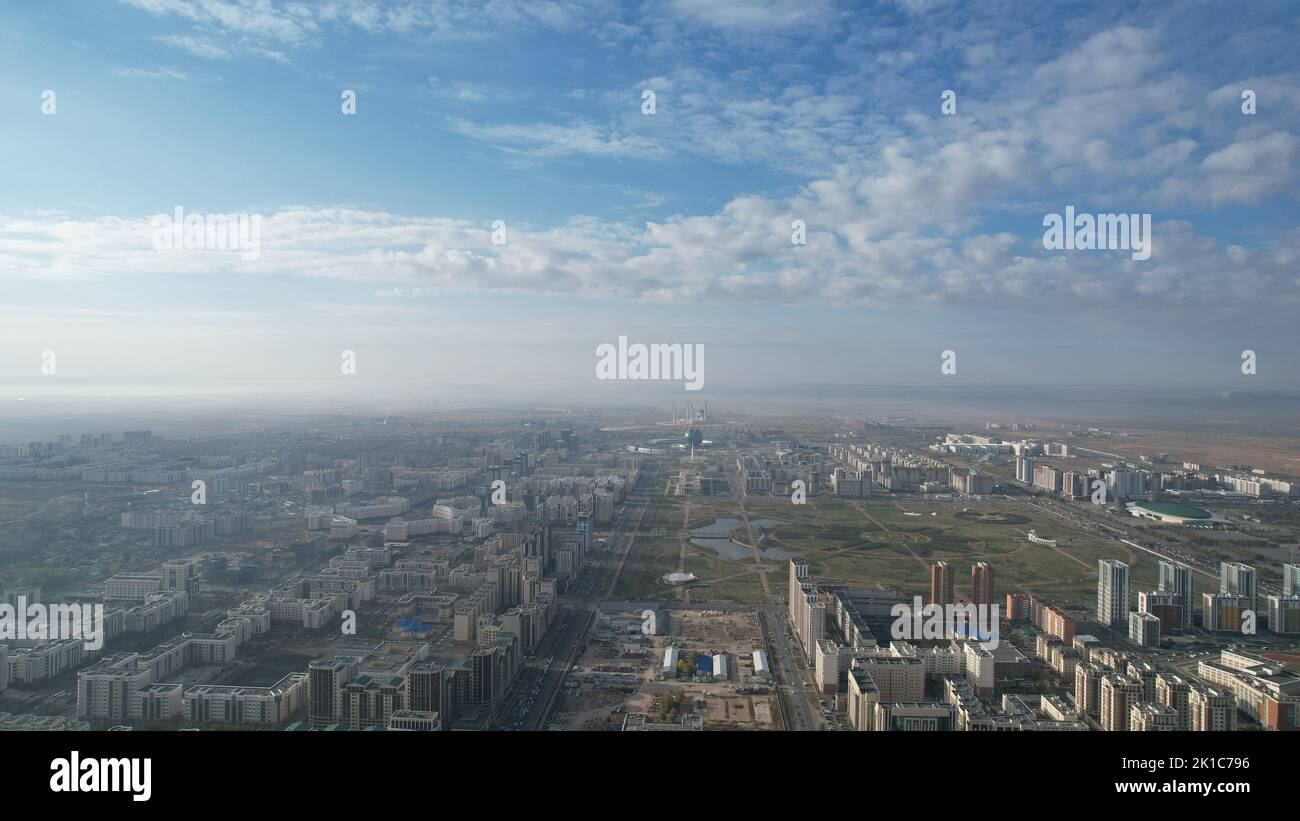 The aerial view of the urban city buildings and park under the blue sky ...