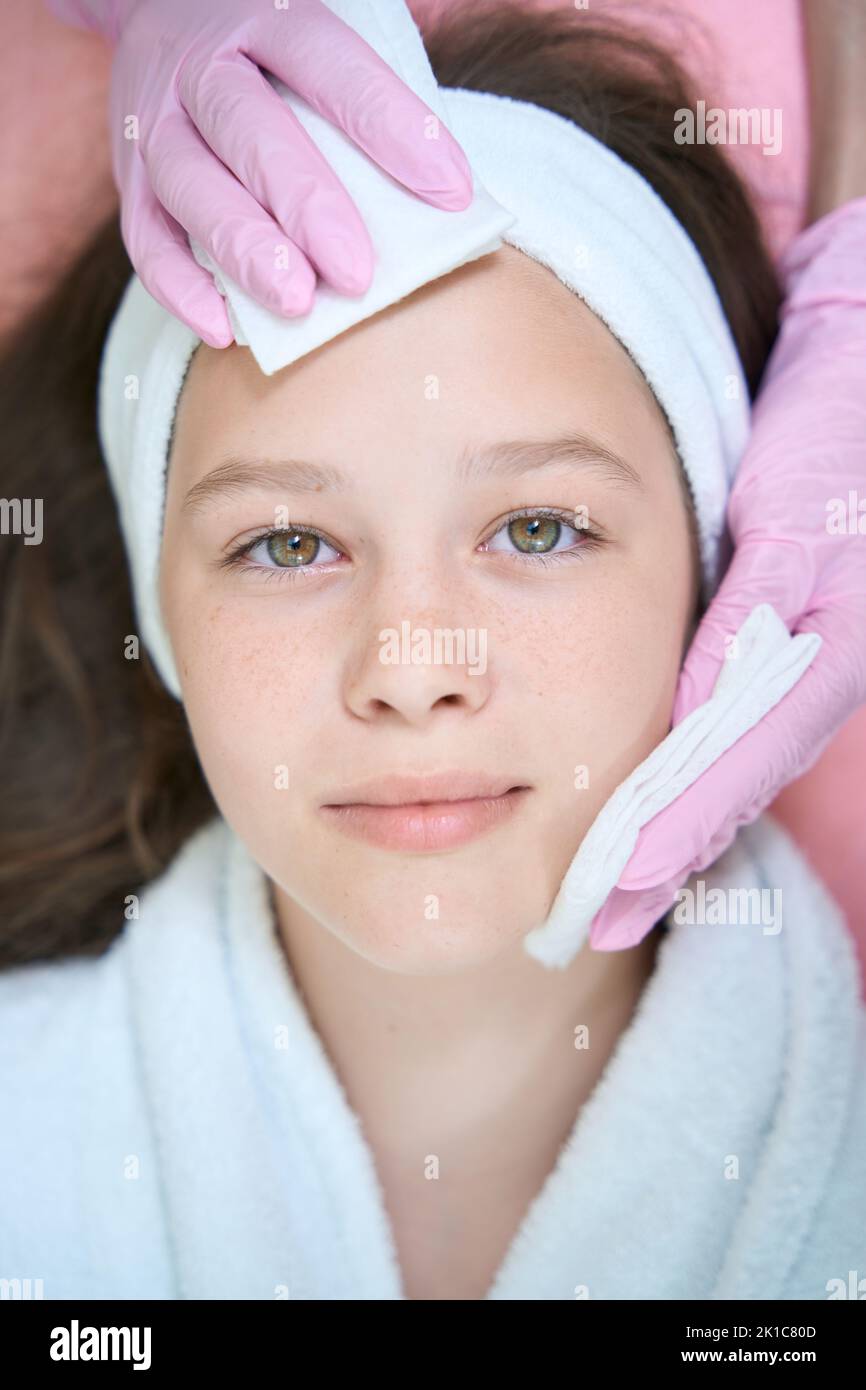 Female hands wipe girl face with napkins in beauty salon Stock Photo ...
