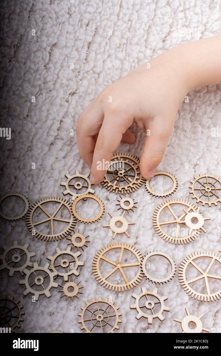 Hand holding gear wheels as the concept of mechanism Stock Photo - Alamy