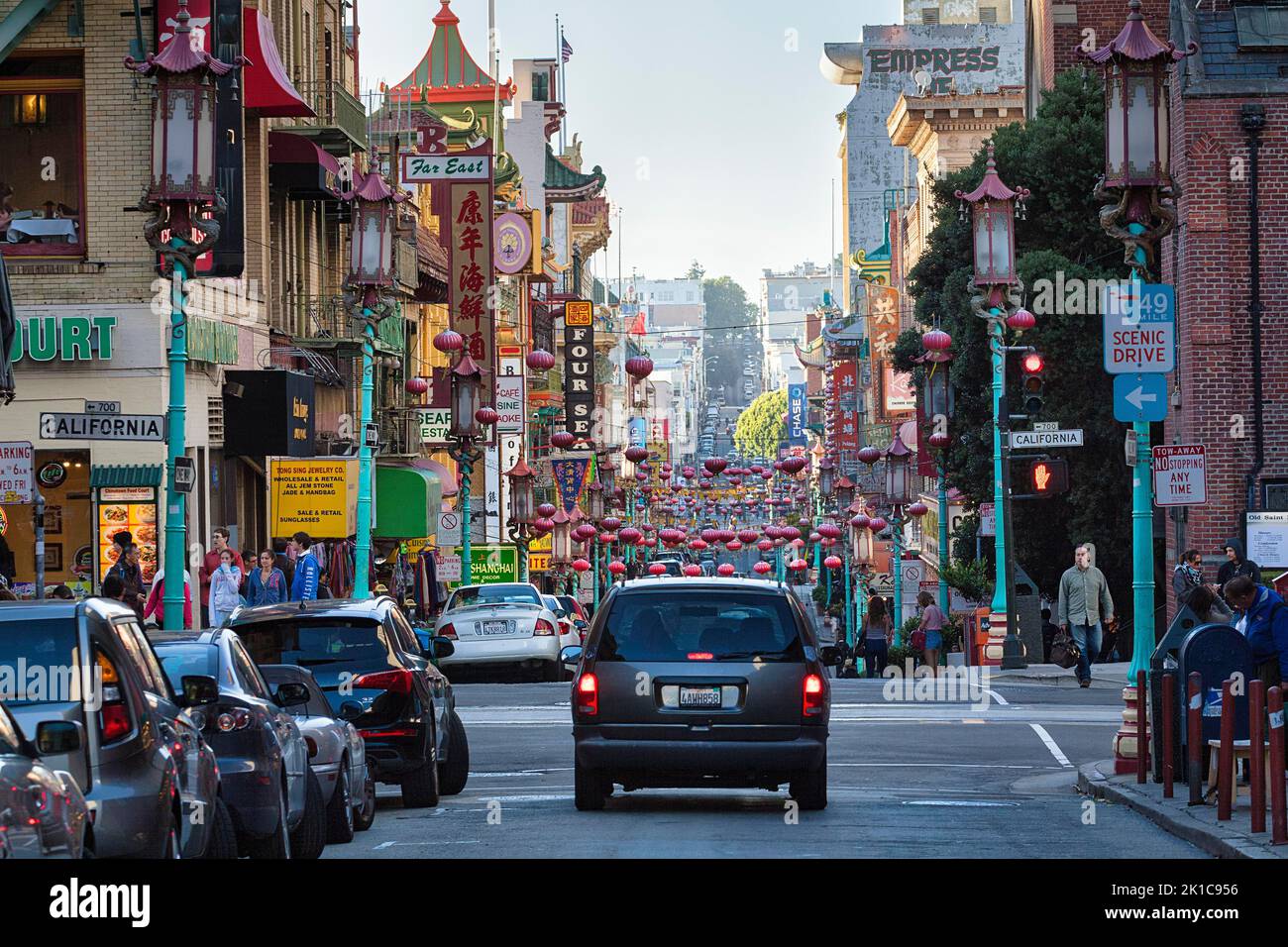 Pedestrians and street traffic, colourful facades with advertising ...