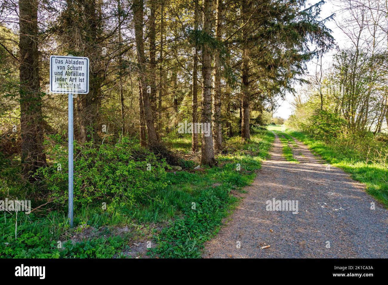 Prohibition sign on the forest path: The unloading of rubble and waste ...