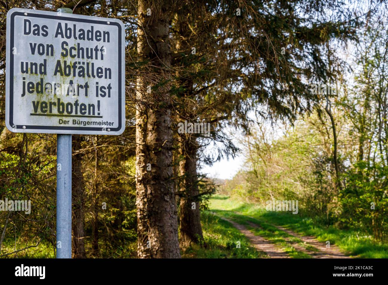 Prohibition sign on the forest path: The unloading of rubble and waste ...